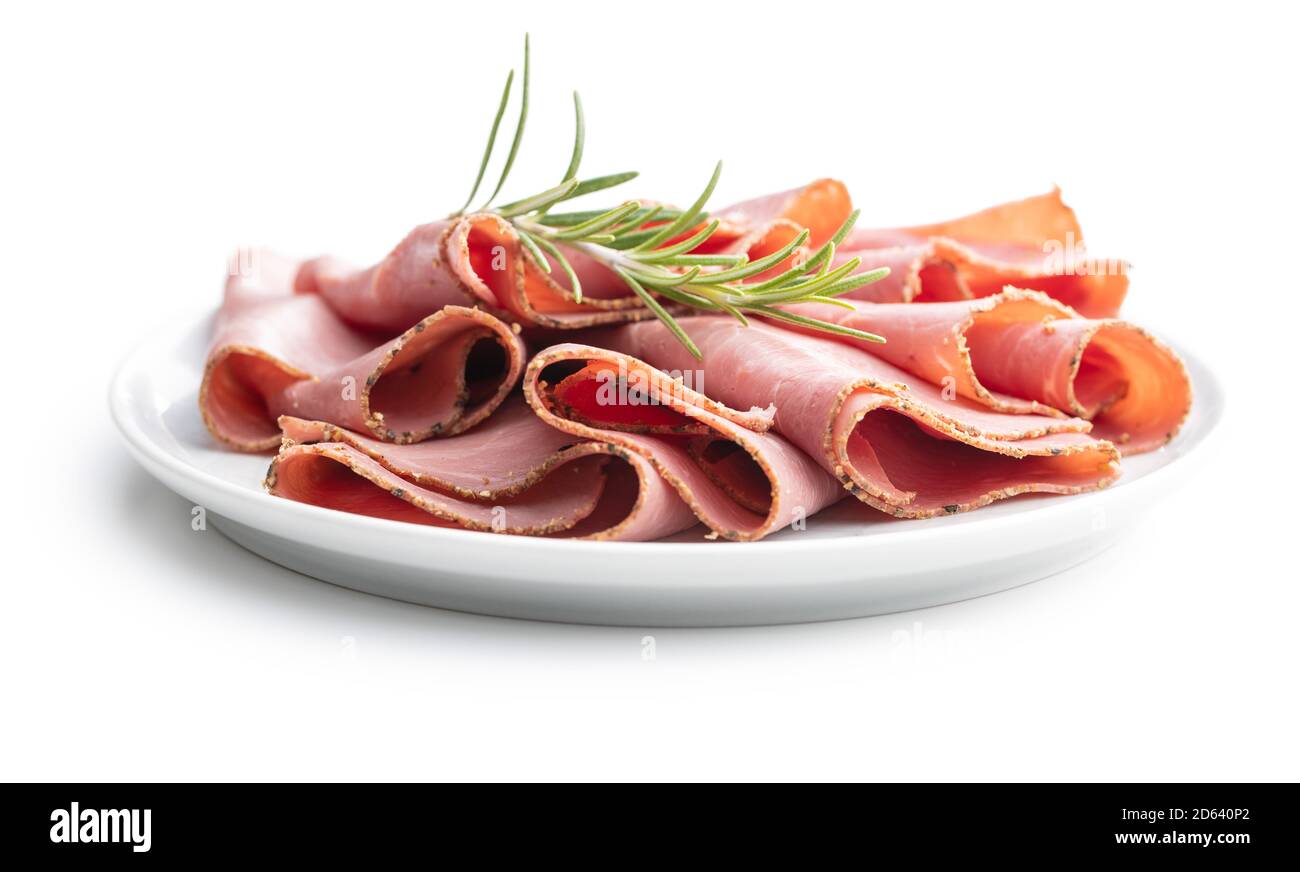 Sliced beef ham on plate isolated on white background Stock Photo - Alamy