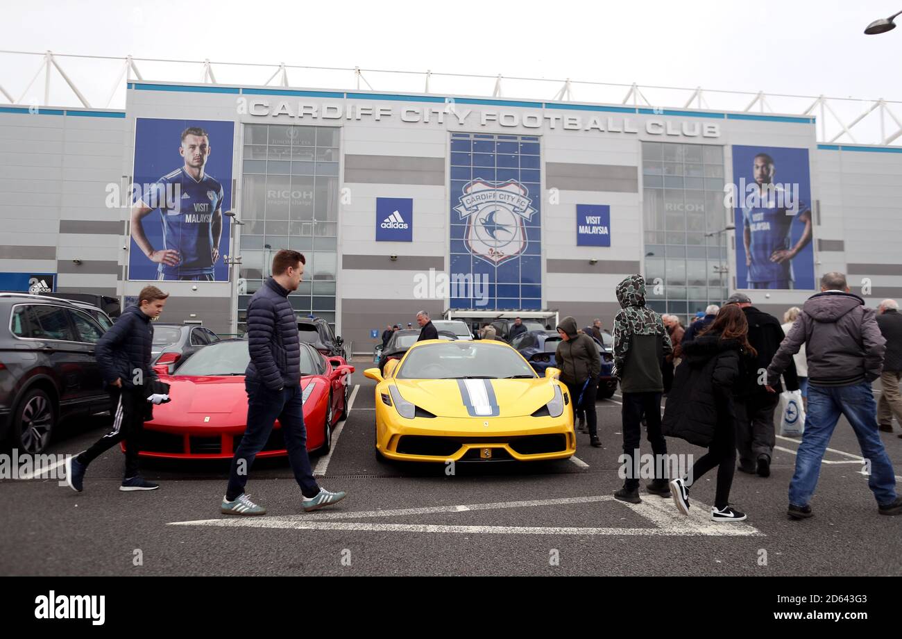 Fans take pictures and look at Ferrari's parked in the car park at the ...