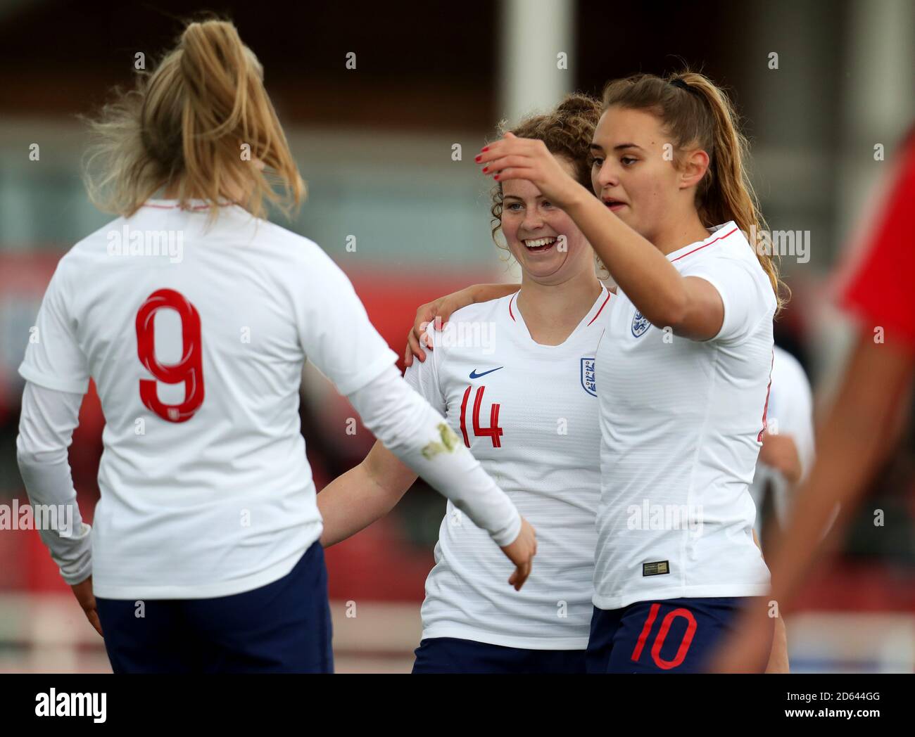 England's Emily Syme celebrates with her team mates after she scores to ...
