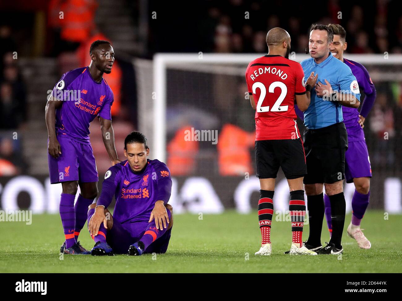 Liverpool's Virgil van Dijk (second left) sits on the floor after a ...