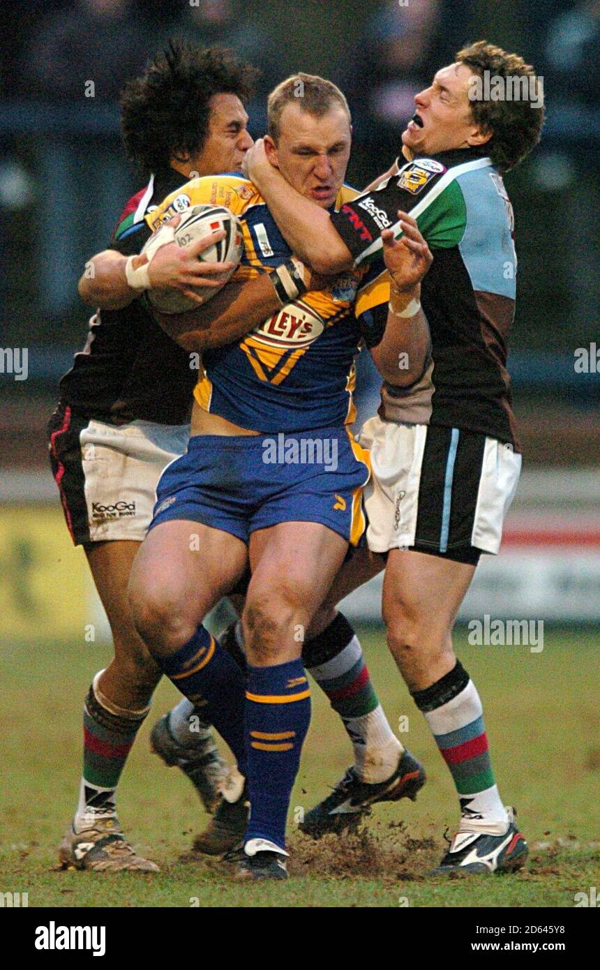 Leeds Rhinos' Carl Ablett (center) is challenged by Harlequins' Rikki ...
