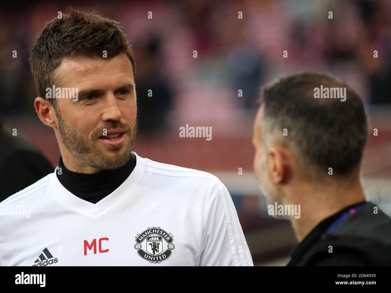 Manchester United's Michael Carrick speaks to Ryan Giggs before kick ...