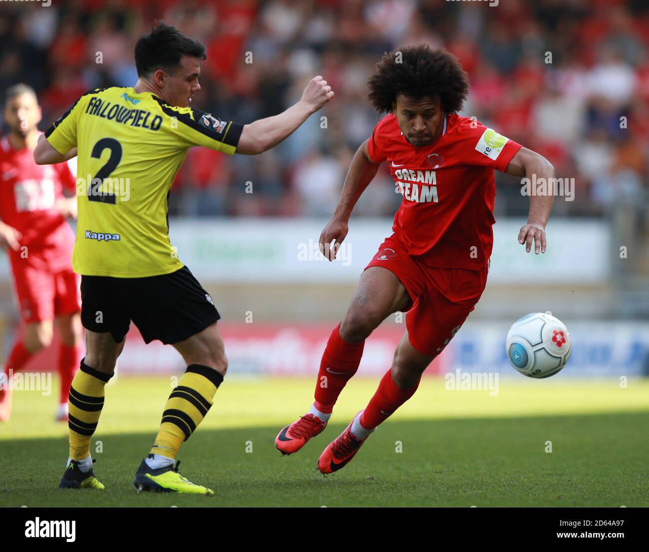 Harrogate Town's Ryan Fallowfield (left) tries to tackle Joe Widdowson ...