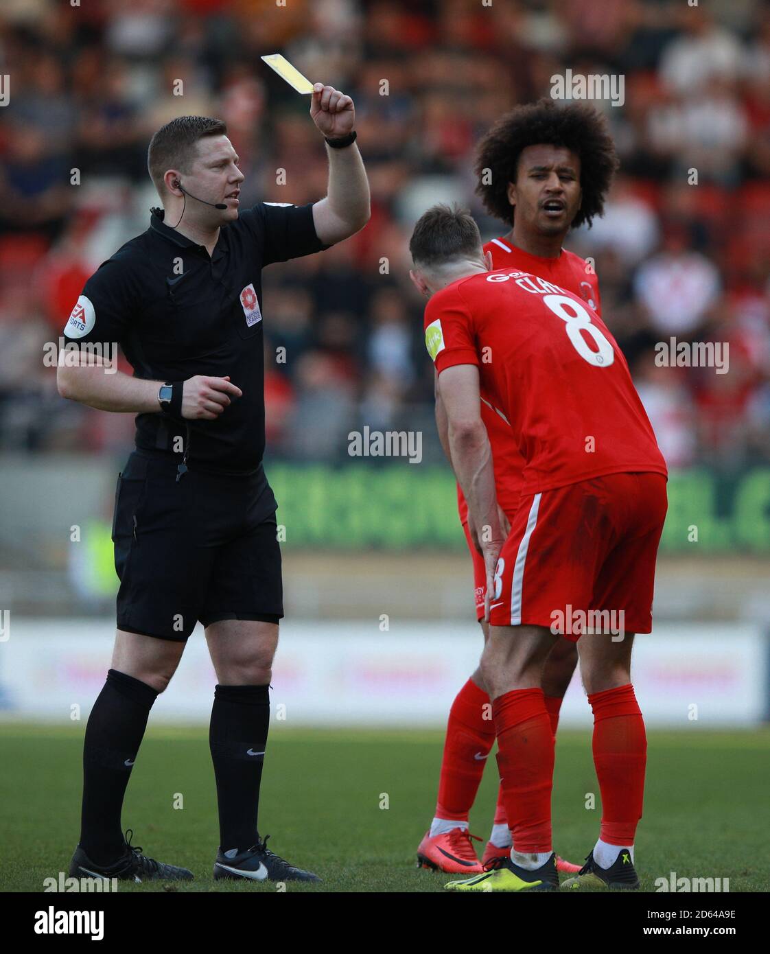 Leyton Orient's Craig Clay (centre) is shown a yellow card by referee ...