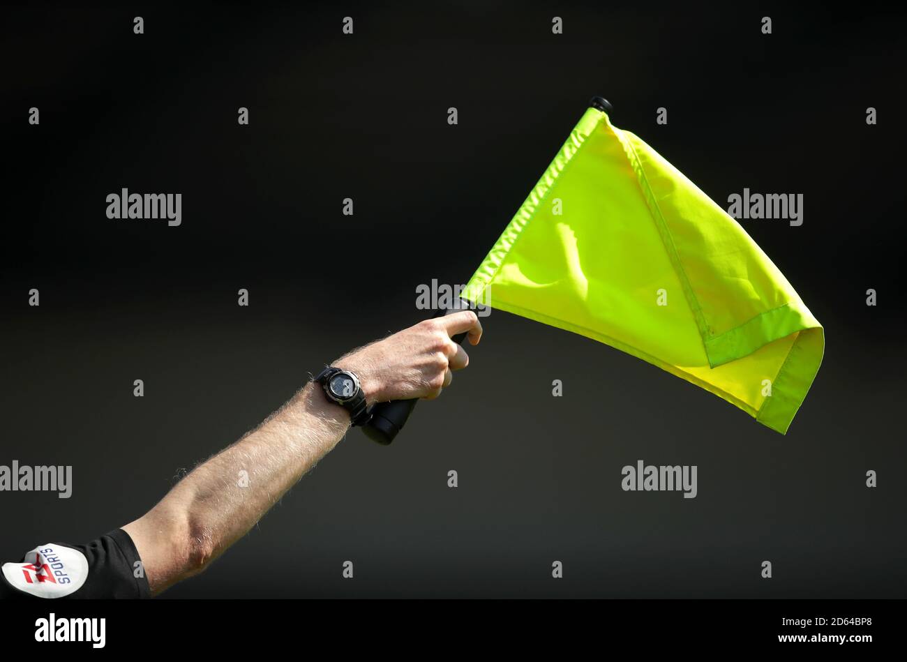 The linesman lifts the yellow flag Stock Photo - Alamy