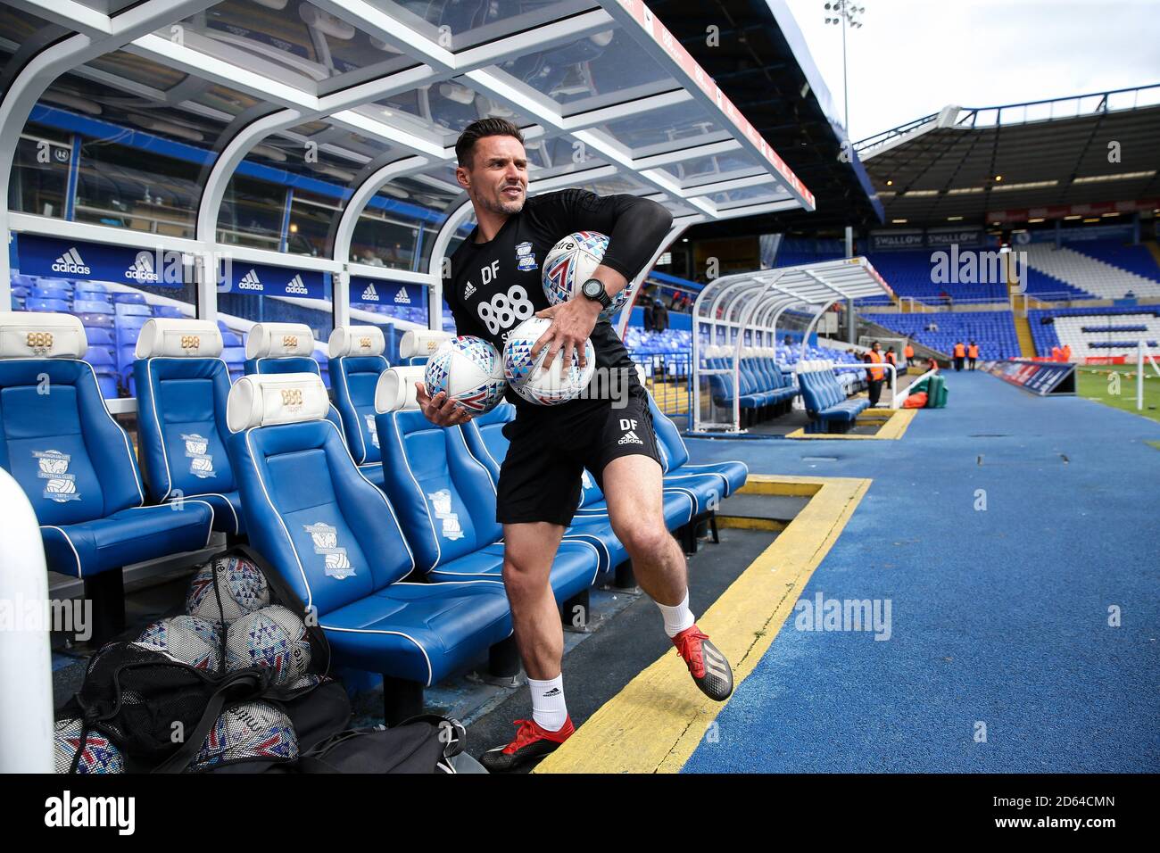 Birmingham City goalkeeper coach Darryl Flahavan collects the practise ...