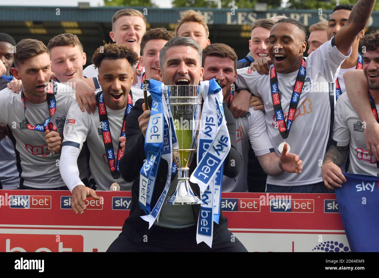 Bury’s manager Ryan Lowe lifts the trophy during a lap of honour as ...
