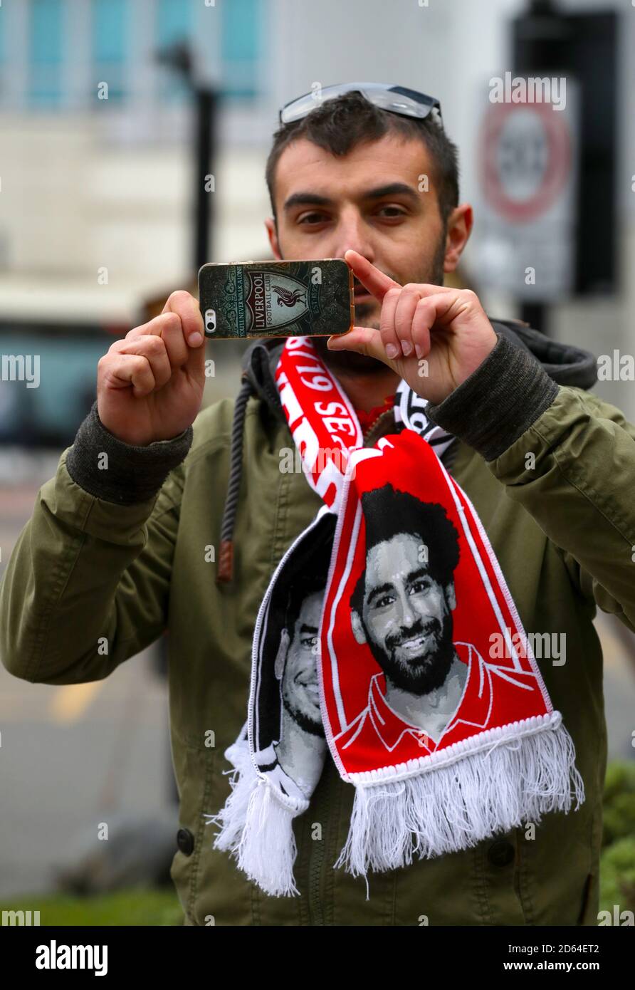 A Liverpool fan takes a photograph ahead of the match Stock Photo - Alamy