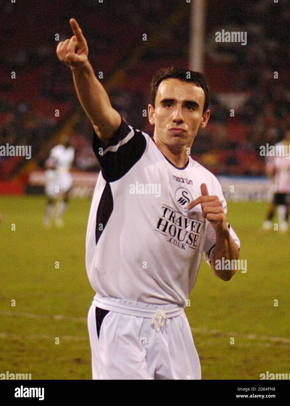 Swansea City's Leon Britton celebrates scoring his sides third goal ...