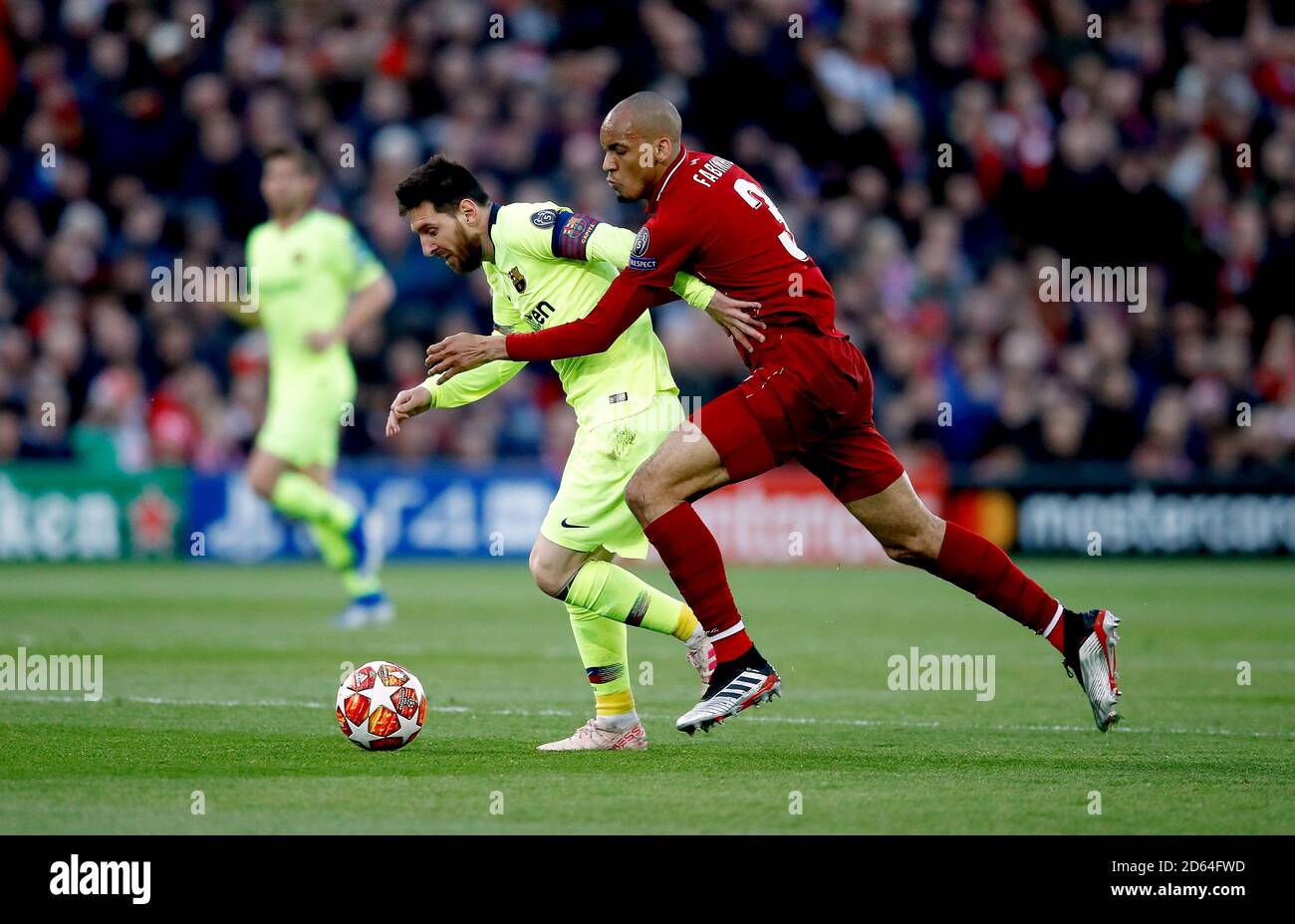 Barcelona's Lionel Messi (left) and Liverpool's Fabinho (right) battle ...