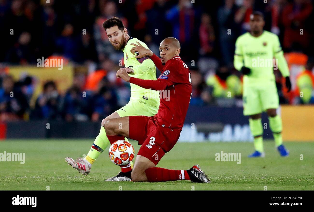 Liverpool's Fabinho (right) and Barcelona's Lionel Messi (left) battle ...