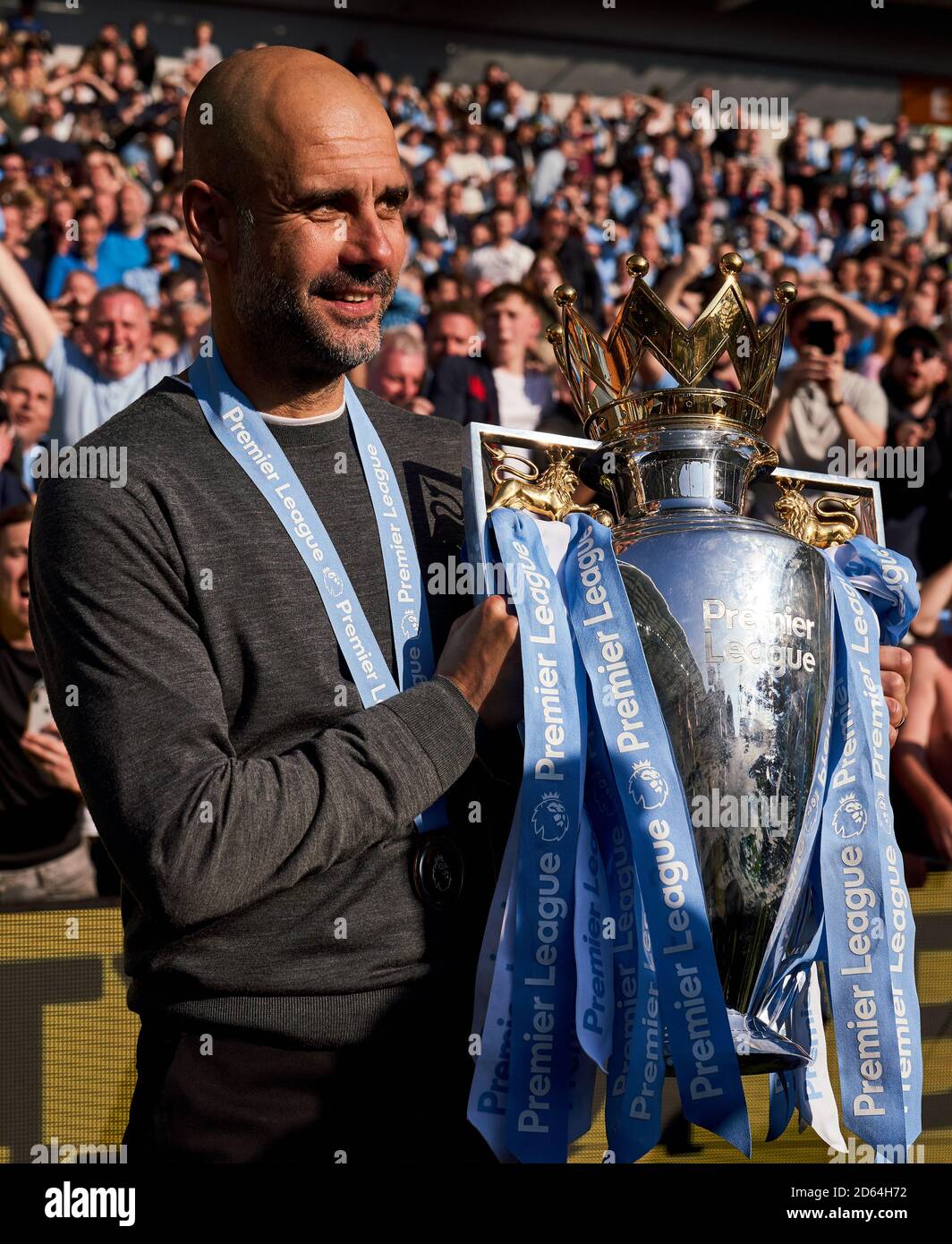 Manchester City Manager Pep Guardiola Celebrates With The Trophy After