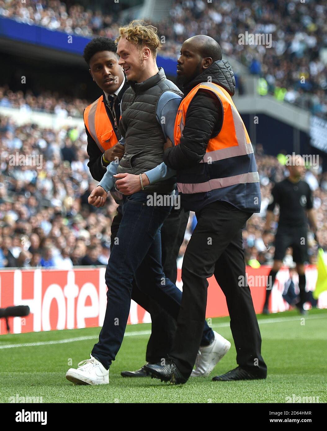 A pitch invader is assorted off the pitch by stewards Stock Photo - Alamy