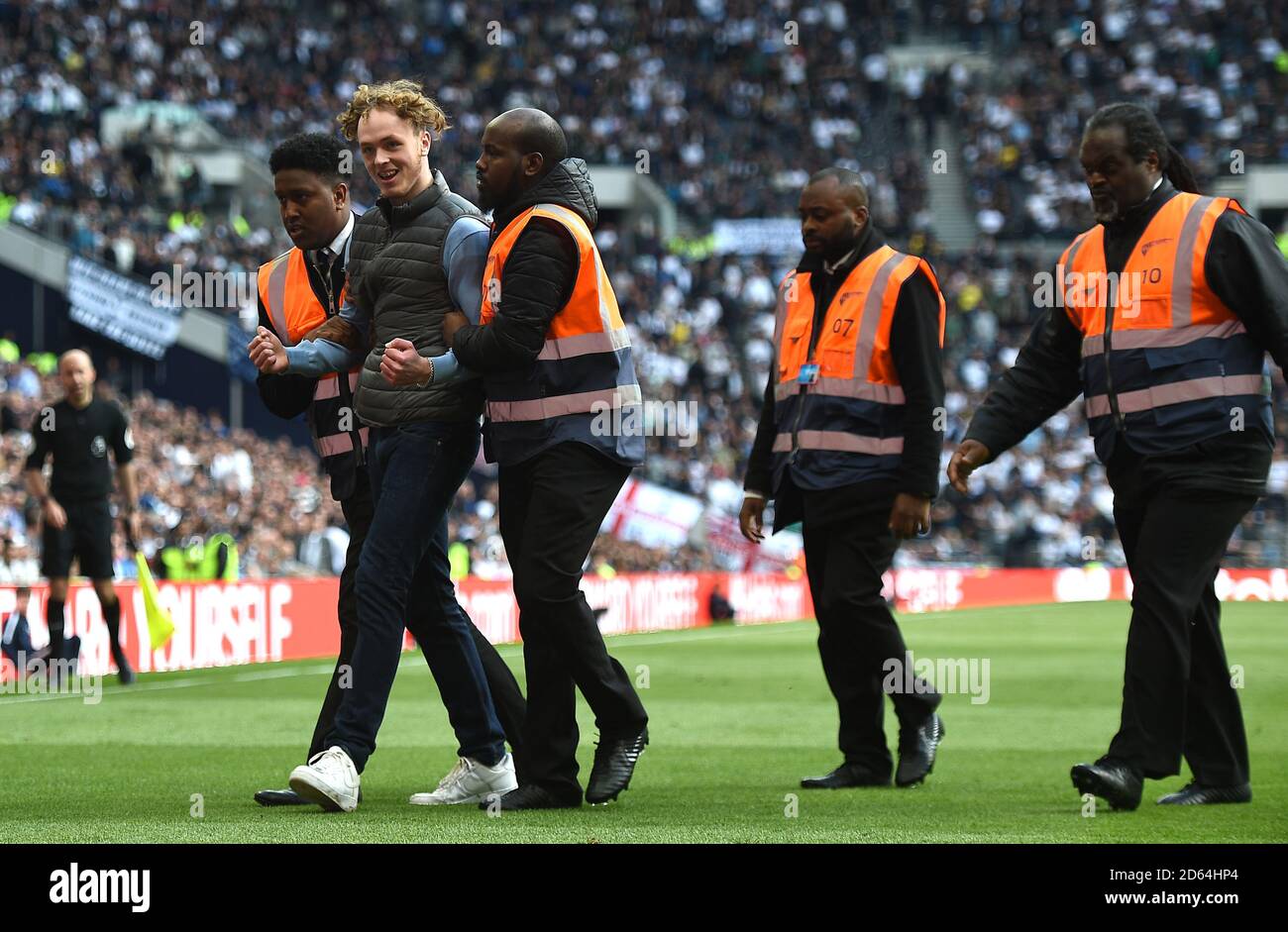 A pitch invader is assorted off the pitch by stewards Stock Photo - Alamy
