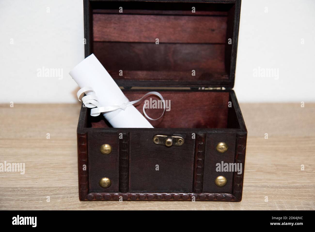 Treasure chest with a rolled blank paper inside of it Stock Photo - Alamy