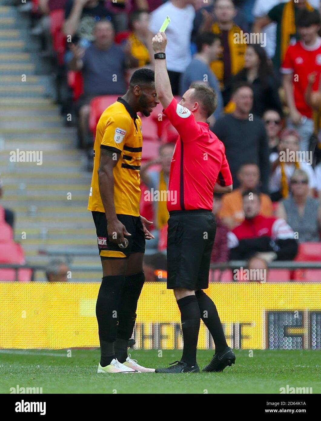 Newport County's Jamille Matt is shown the yellow card by referee Ross ...