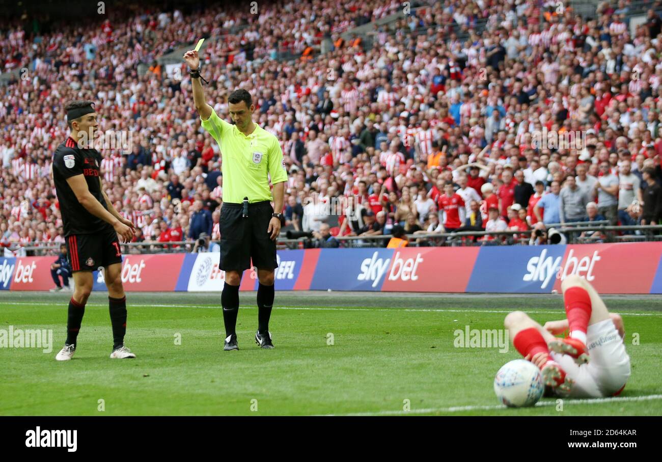 Sunderland's Luke O'Nein is shown a yellow card by match referee Andrew ...