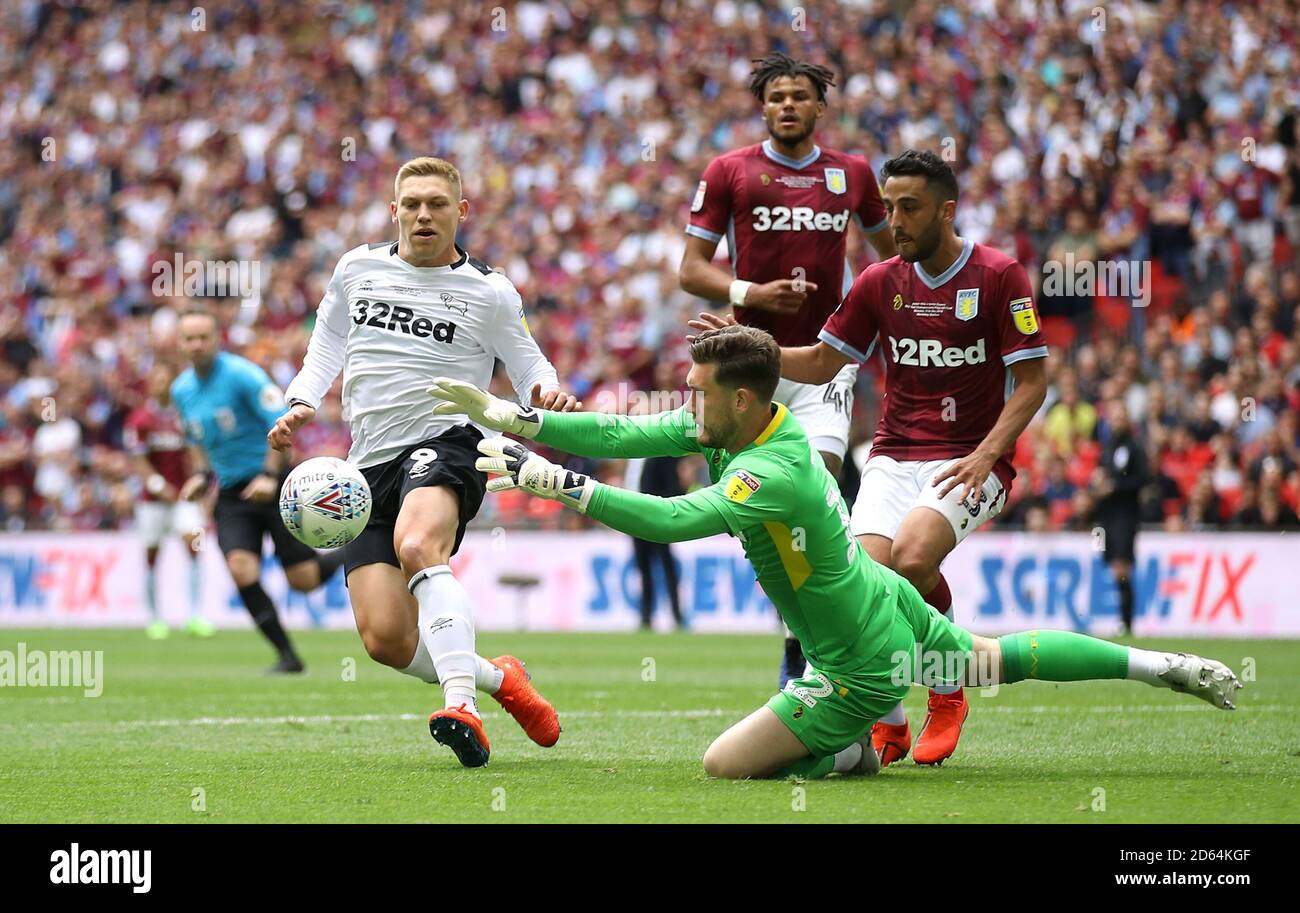 Aston Villa goalkeeper Jed Steer (right) makes a save from Derby County ...