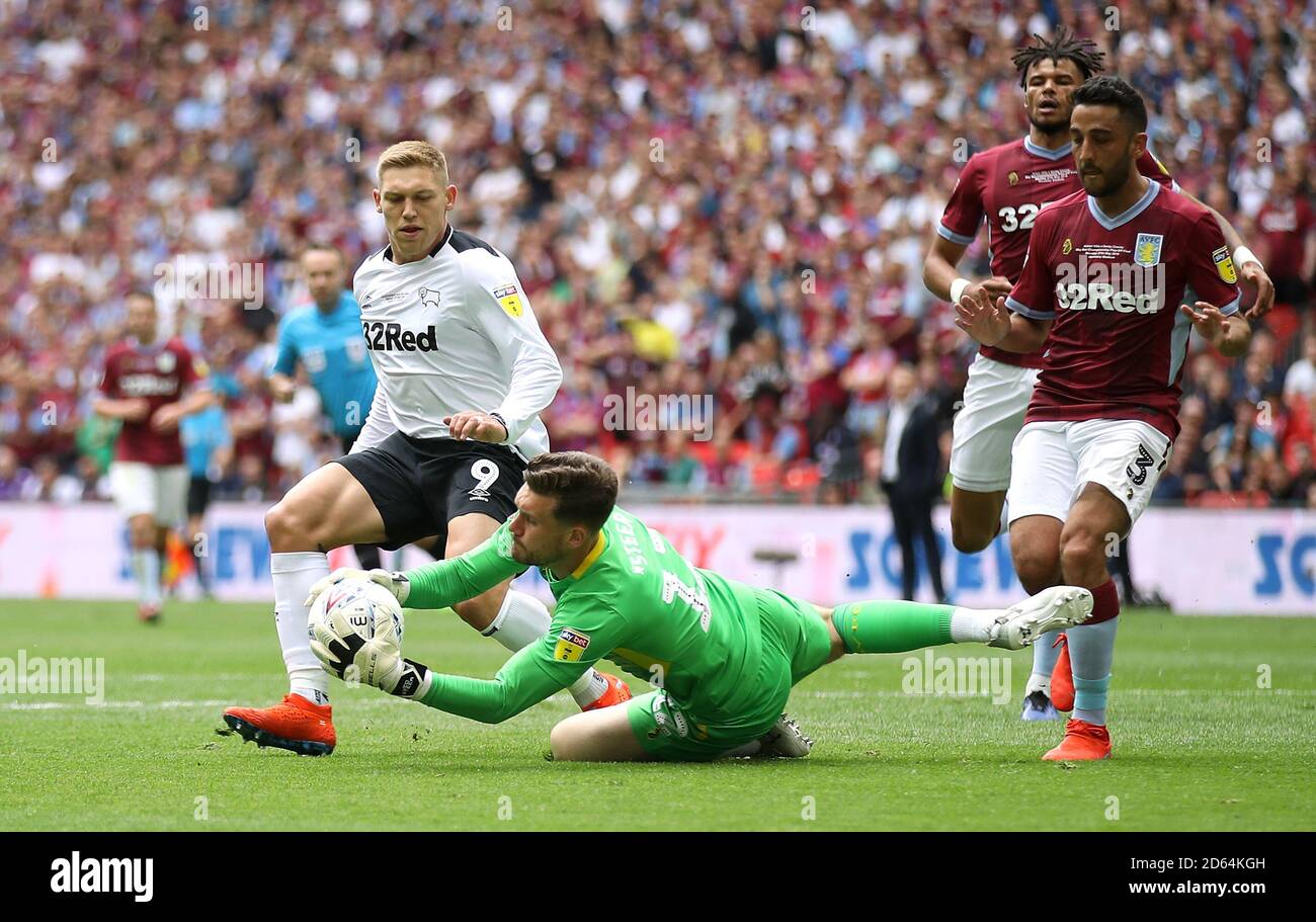 Aston Villa goalkeeper Jed Steer (right) makes a save from Derby County ...