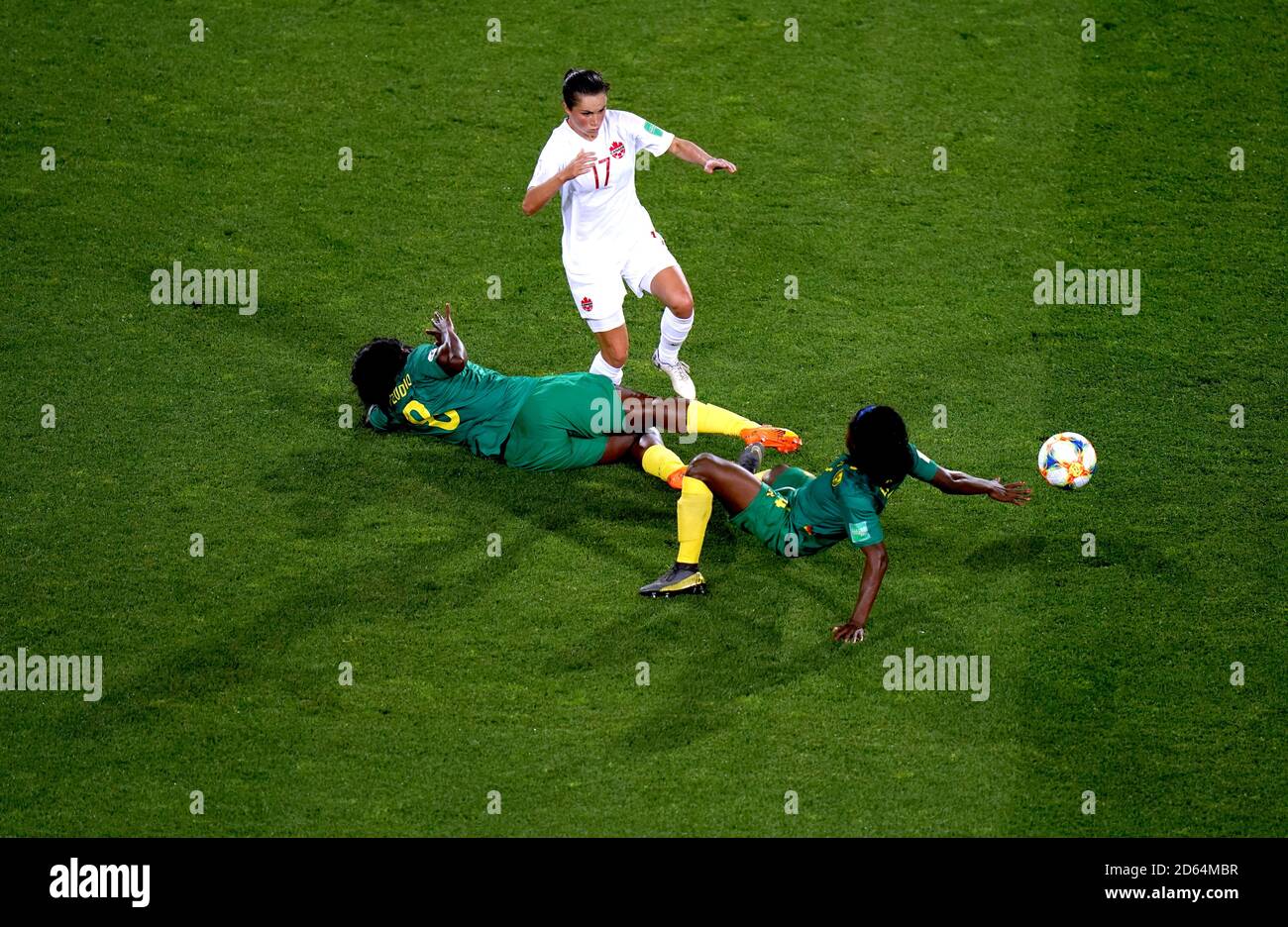 Canada's Jessie Fleming (centre) battles for the ball with Cameroon's ...