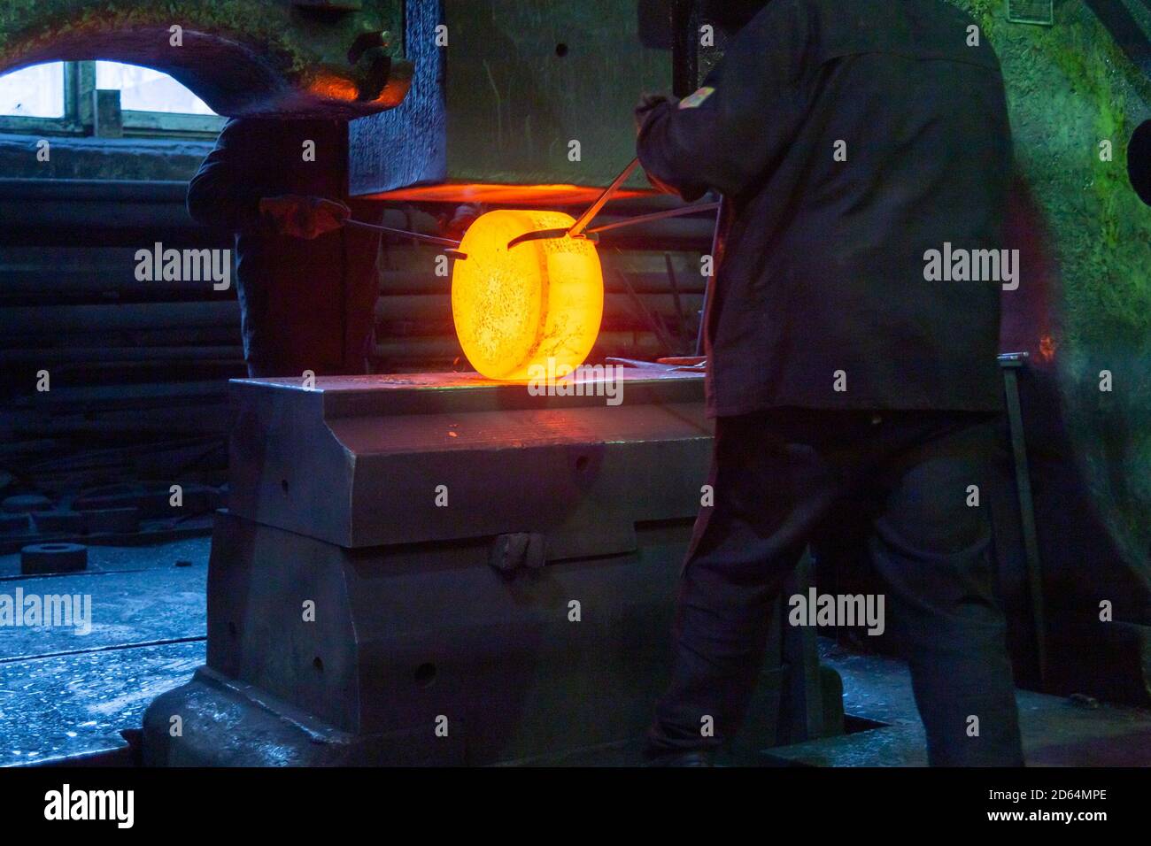 close-up picture of hot steel free forging process with big mechanical ...
