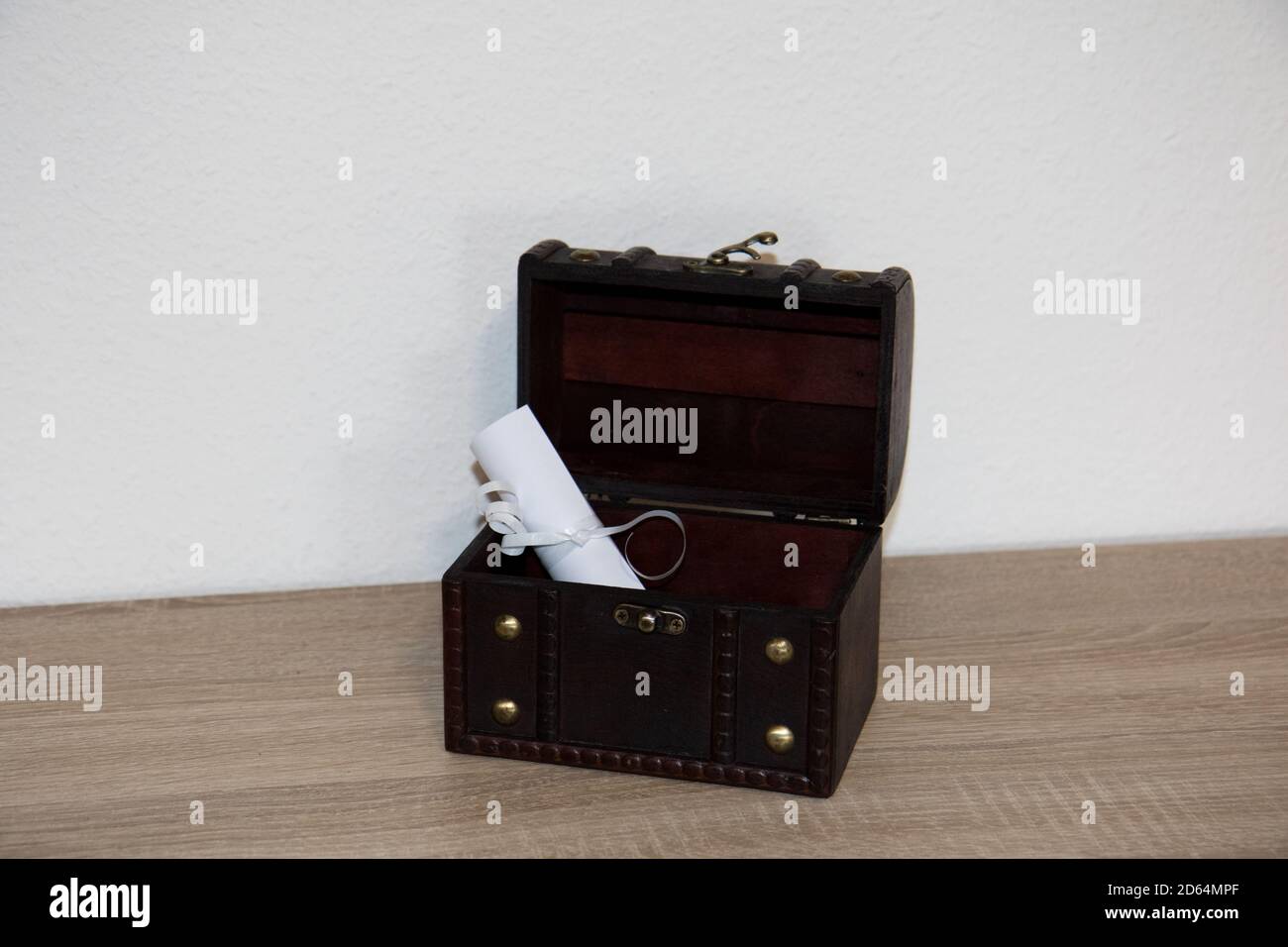 Treasure chest with a rolled blank paper inside of it Stock Photo - Alamy