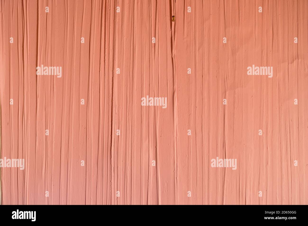 a Full frame of a terracotta painted old wall with wallpaper and ...
