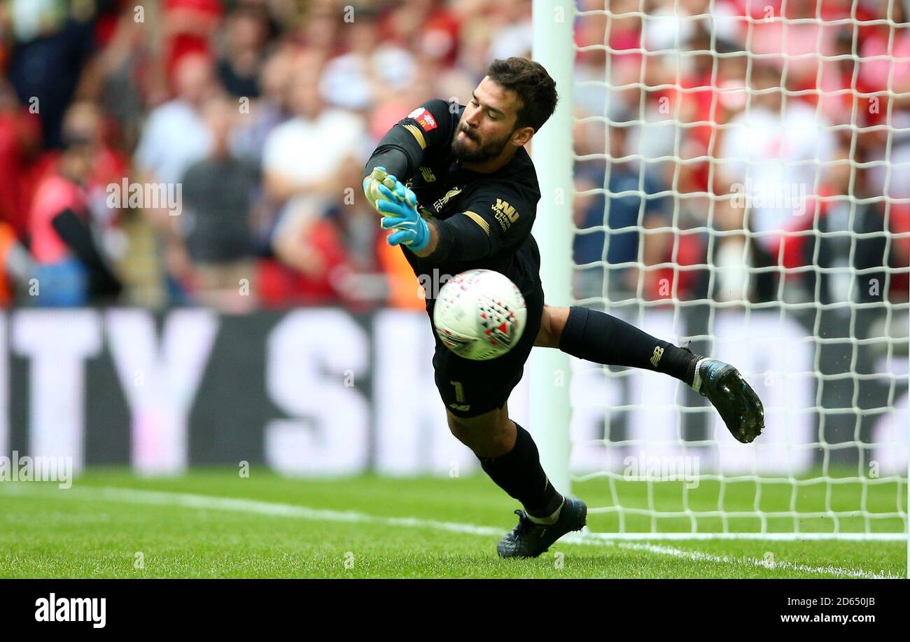 Liverpool goalkeeper Alisson saves a penalty during the shoot out Stock ...