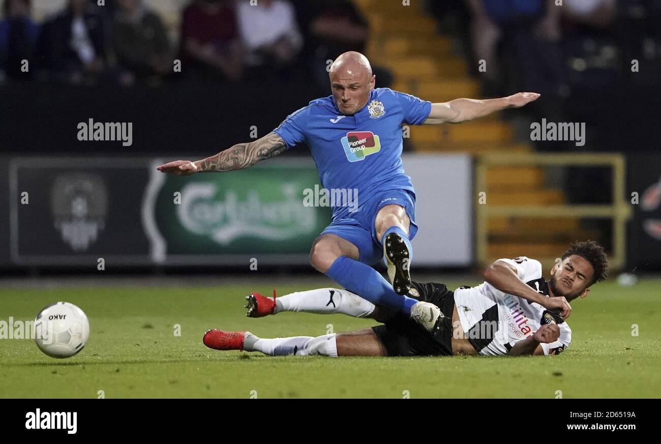 Notts County's Dion Kelly-Evans (right) makes a challenge on Stockport ...