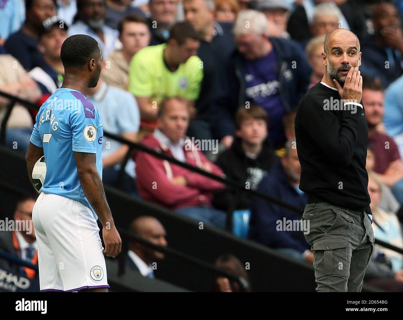 Manchester City manager Pep Guardiola (right) speaks with Raheem ...