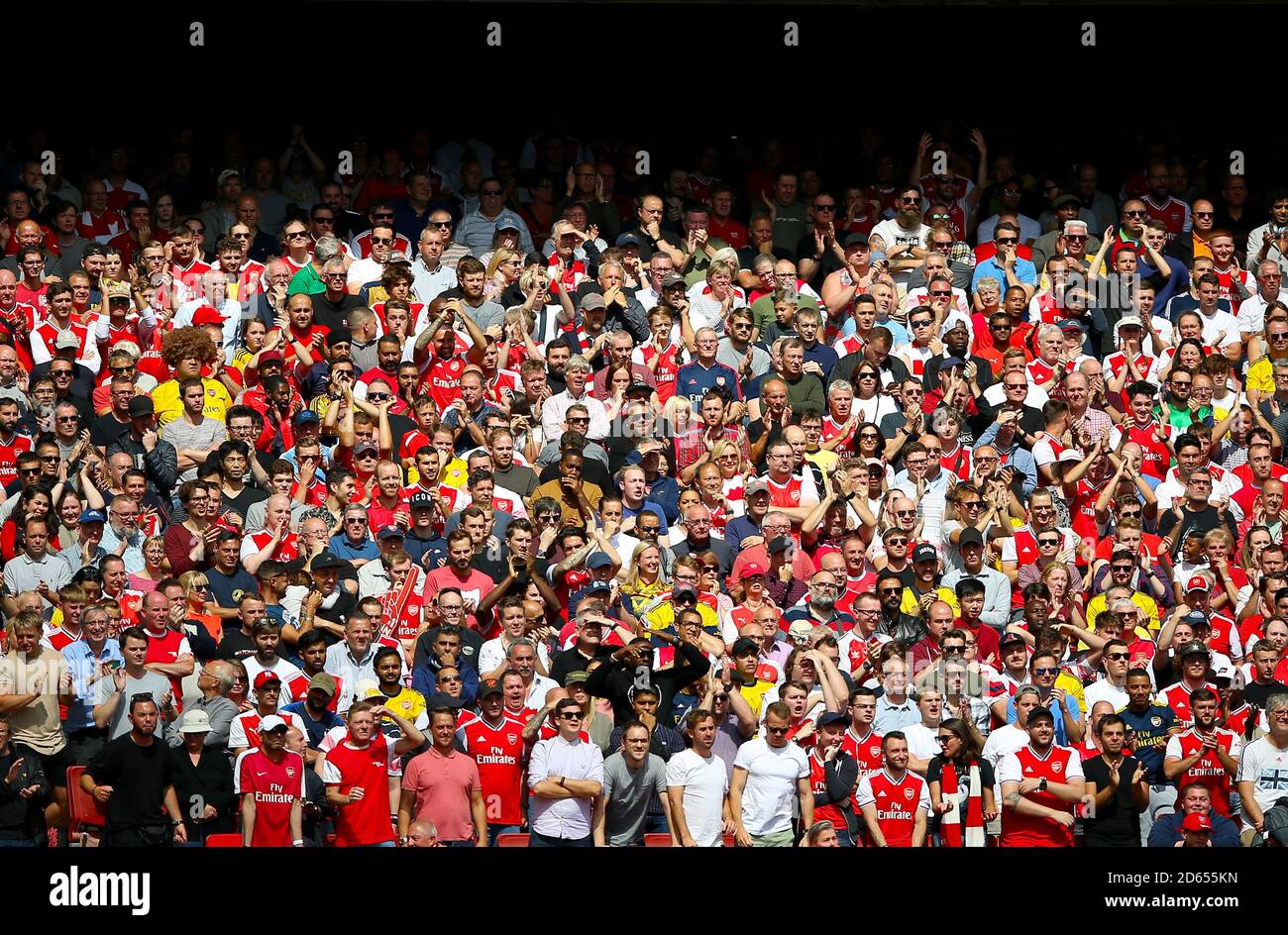 Arsenal fans in the stands Stock Photo - Alamy