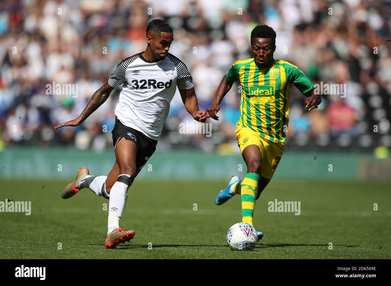 Derby County's Max Lowe holds off challenge from West Bromwich Albion's ...