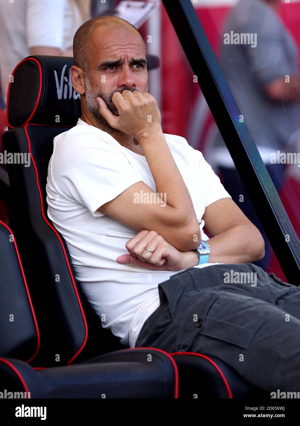 Manchester City manager Pep Guardiola on the bench before the match ...