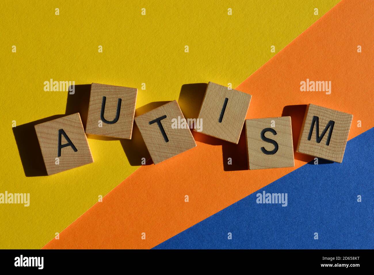 Autism, word in wooden alphabet letters isolated on colourful ...