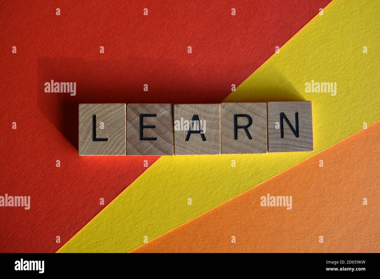 Learn, word in wooden alphabet letters isolated on colourful background ...