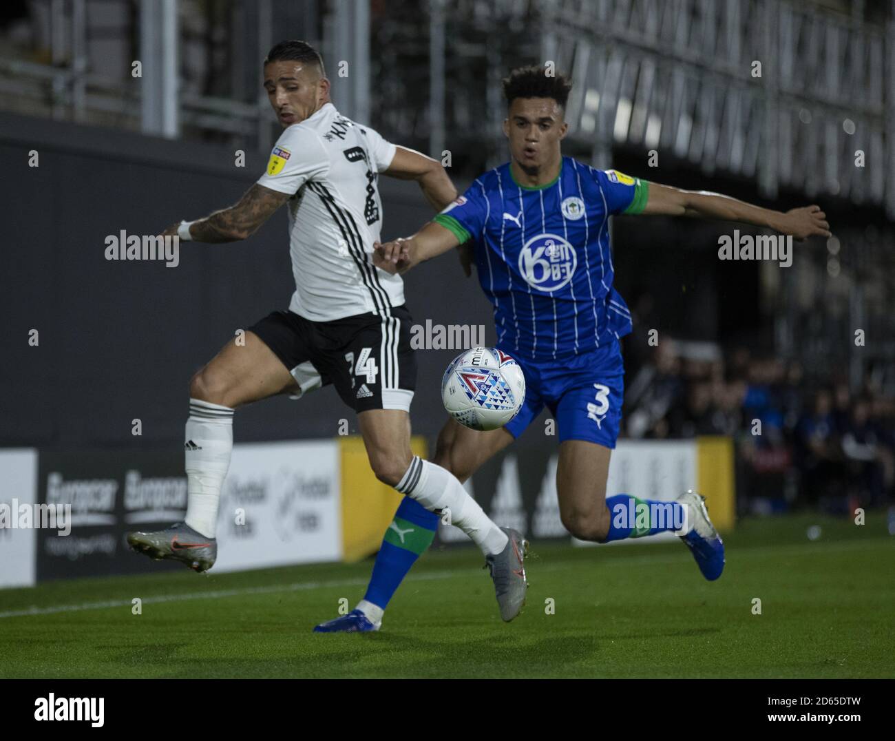 Antonee Robinson of Wigan Athletic tries to tackle Anthony Knockaert of ...