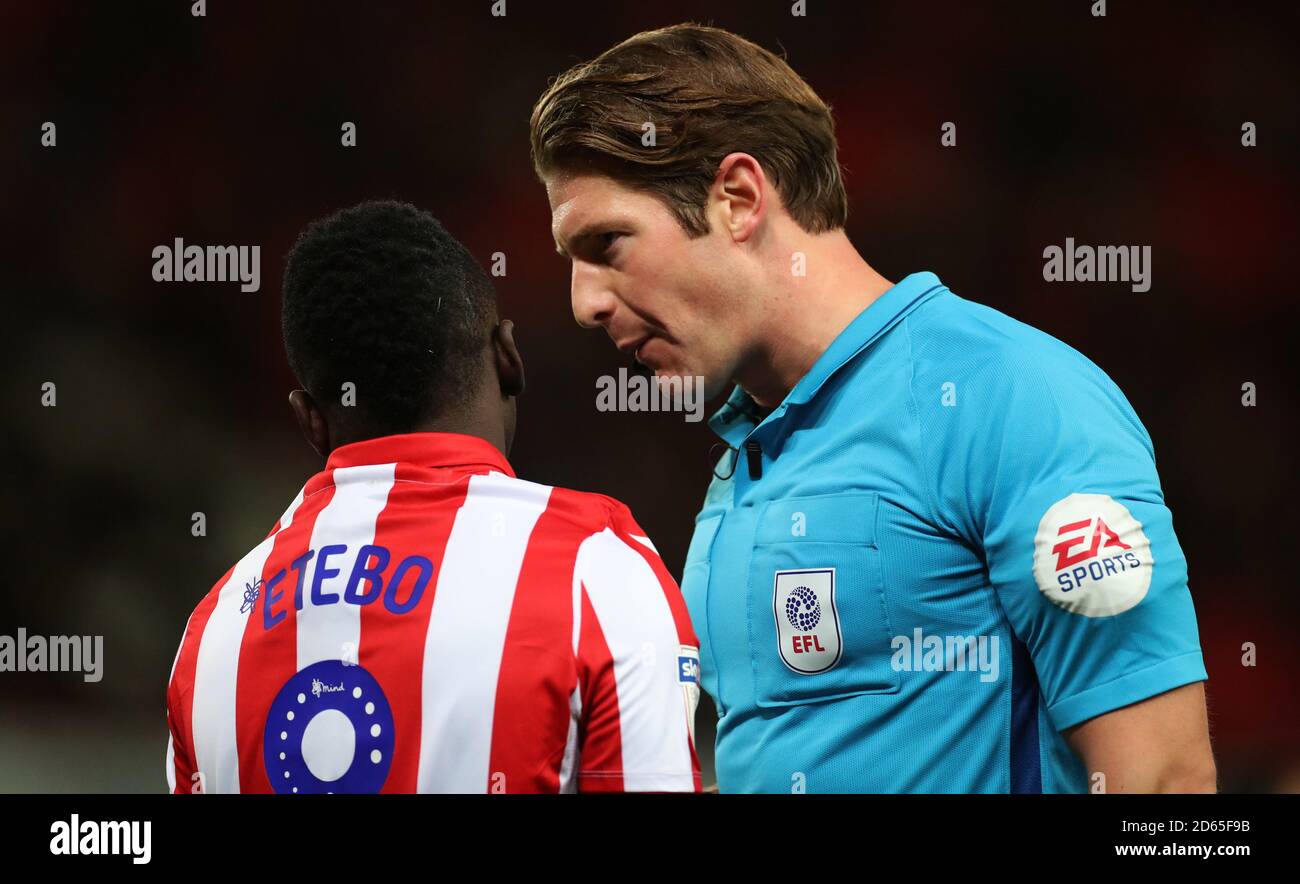 Referee Robert Jones talks with Stoke City's Peter Etebo Stock Photo ...