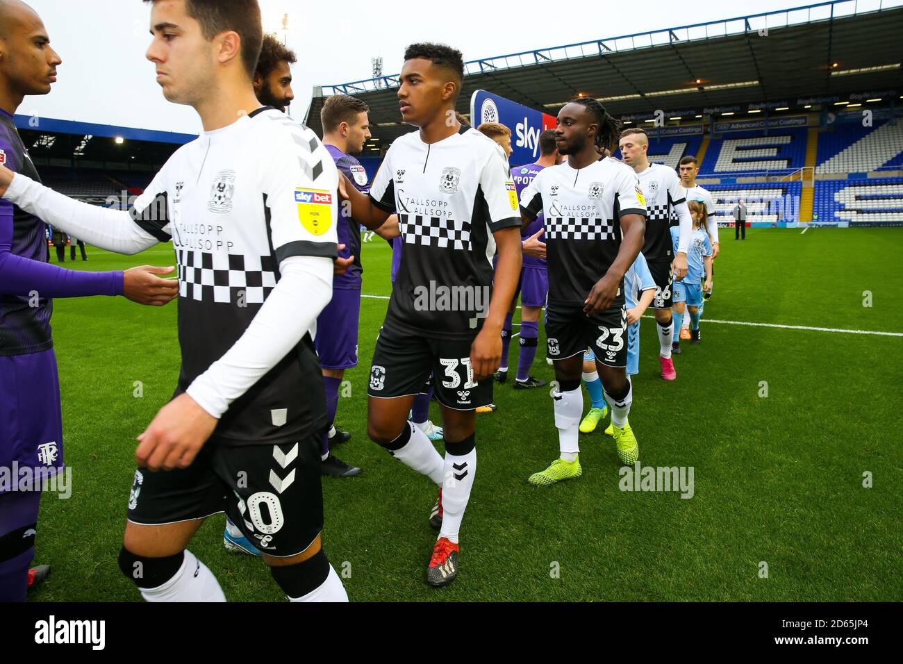 Coventry City's players and mascots shake hand with the Tranmere Rovers ...