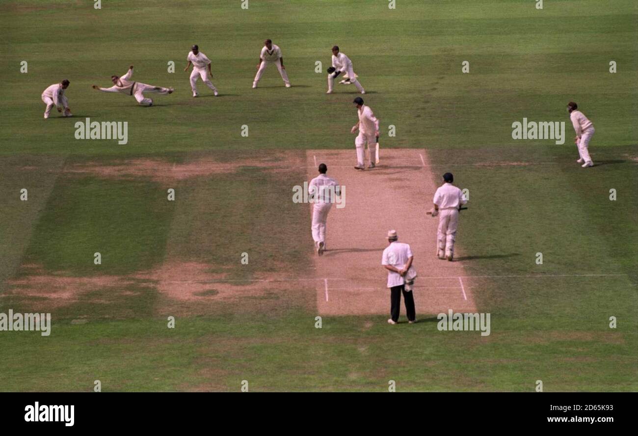 Surrey's Ian Salisbury (second r) dives in an attempt to take a slip ...