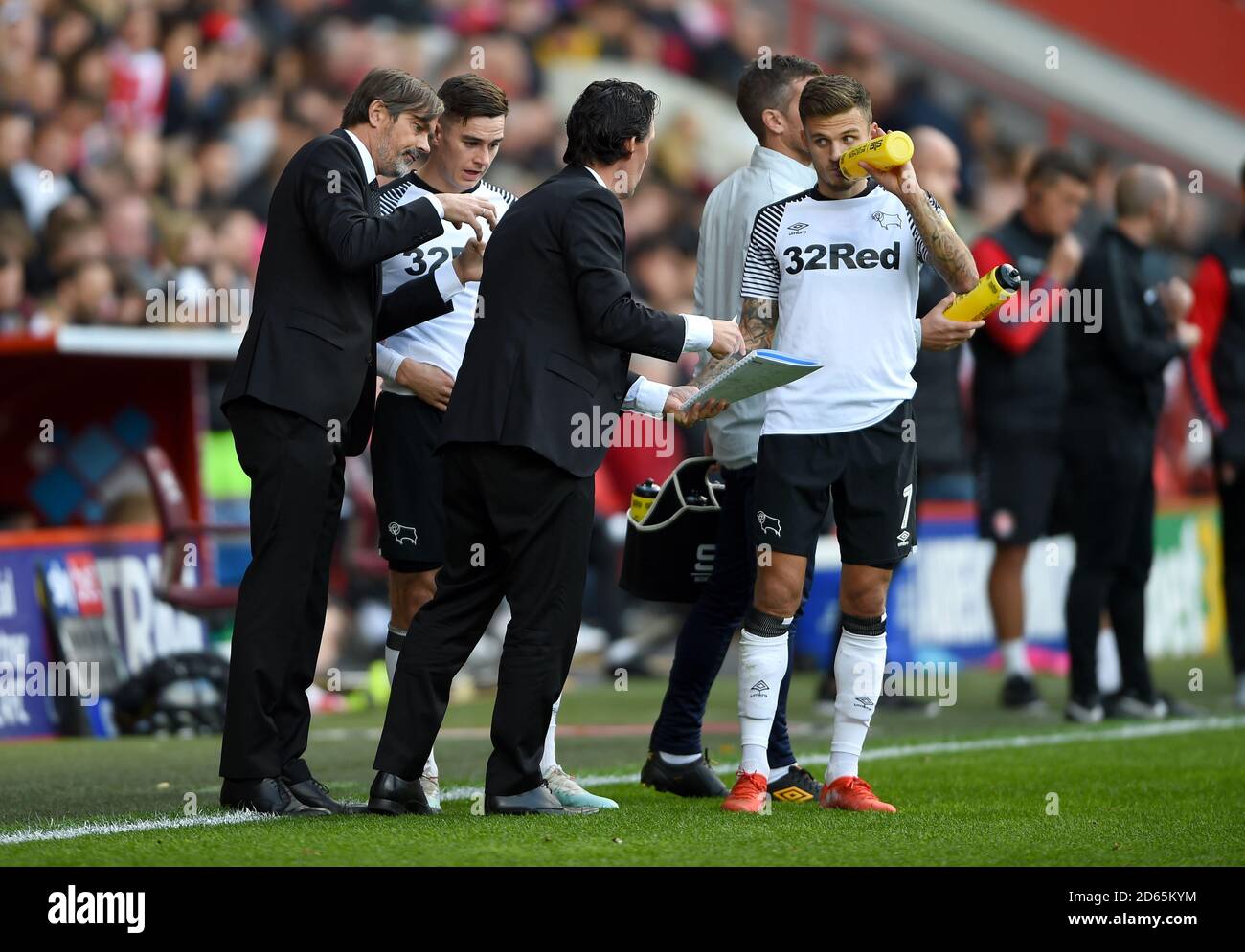 Derby County manager Phillip Cocu speaks with Derby County's Tom ...