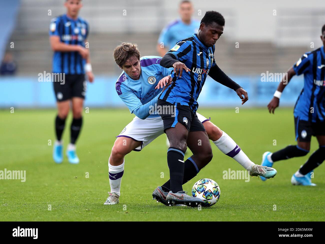 Manchester City's Adrian Bernabe (left) and Atalanta's Manu Emmanuel Gyabuaa (right) battle for ...