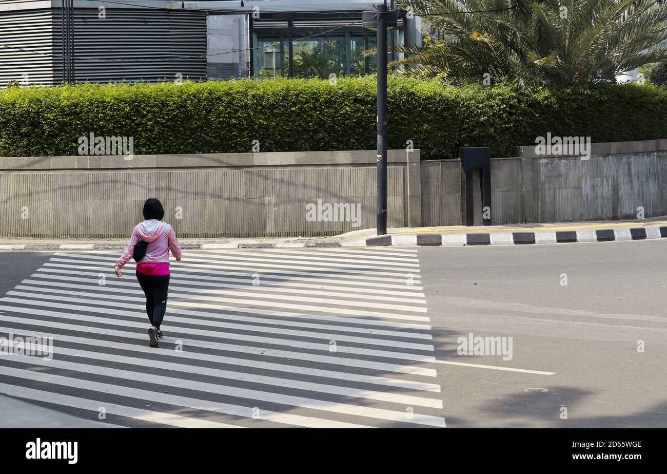 a woman who is crossing the zebra crossing. suitable for obedient ...