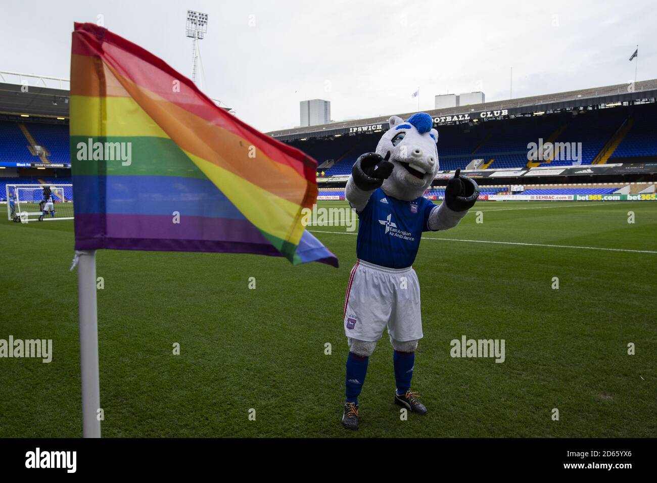 Ipswich Town mascot "Bluey" poses next to a Rainbow Laces corner flags ...