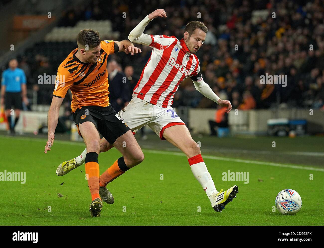 Hull City's Reece Burke (left) and Stoke City's Nick Powell battle for ...