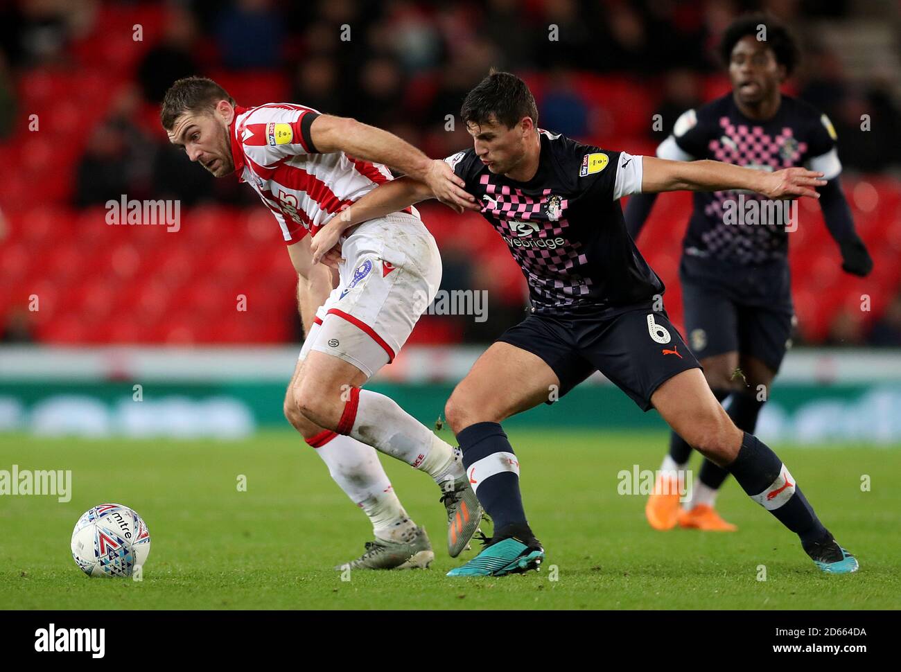 Stoke City's Sam Vokes (left) and Luton Town's Matty Pearson battle for ...