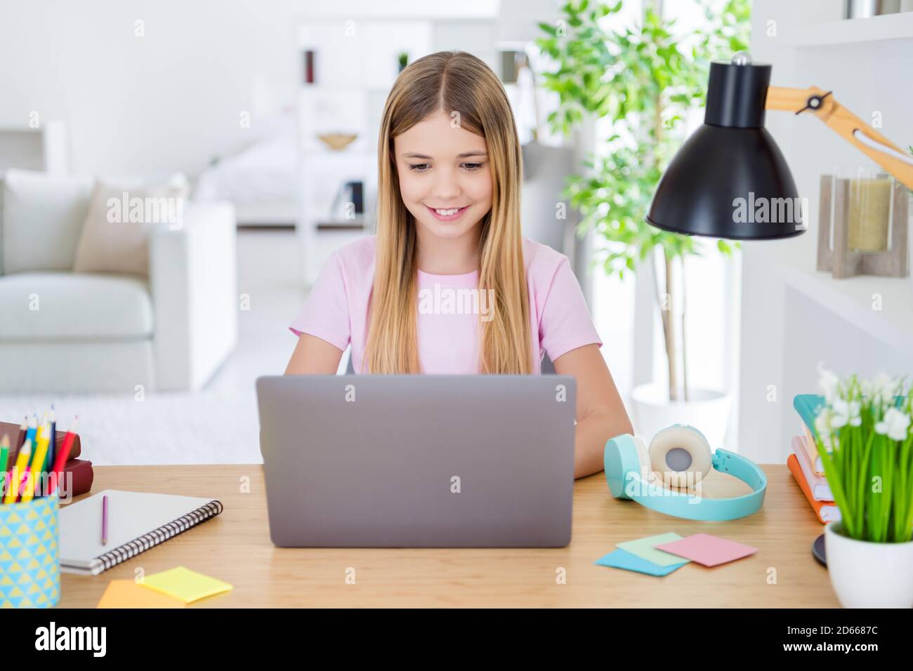 Photo of positive kid girl study remote sit desk table use laptop have ...