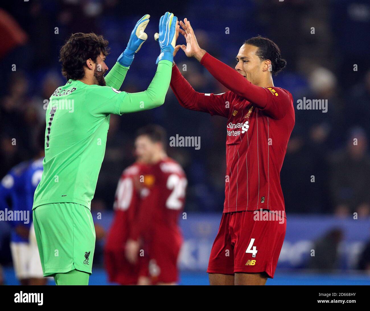 Liverpool's Virgil van Dijk and goalkeeper Alisson (left) celebrate ...