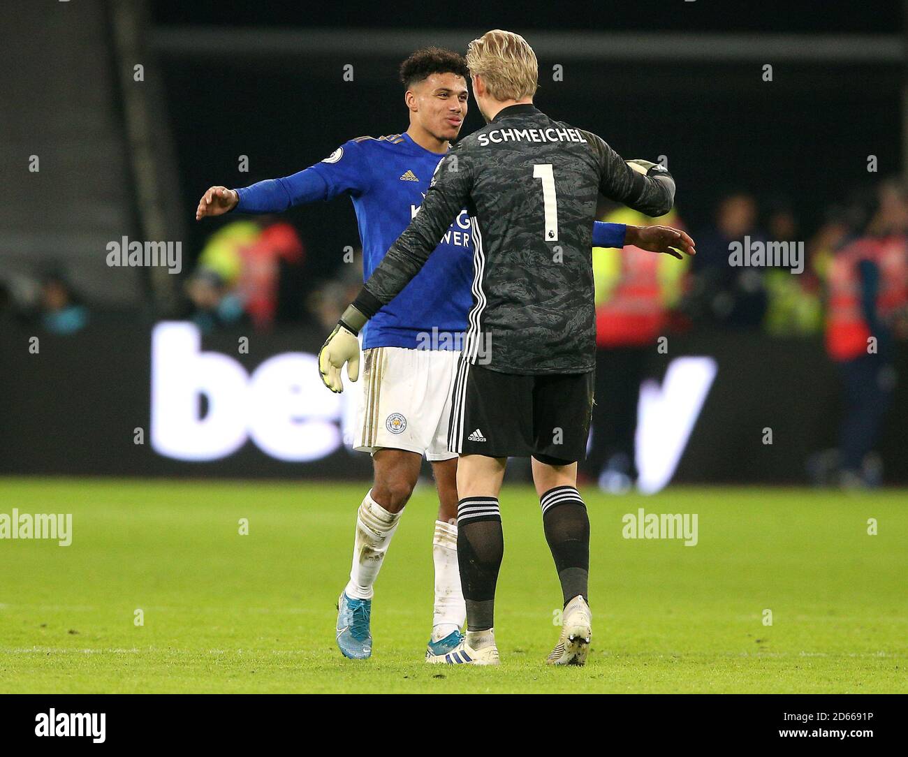 Leicester City's James Justin (left) and goalkeeper Kasper Schmeichel ...