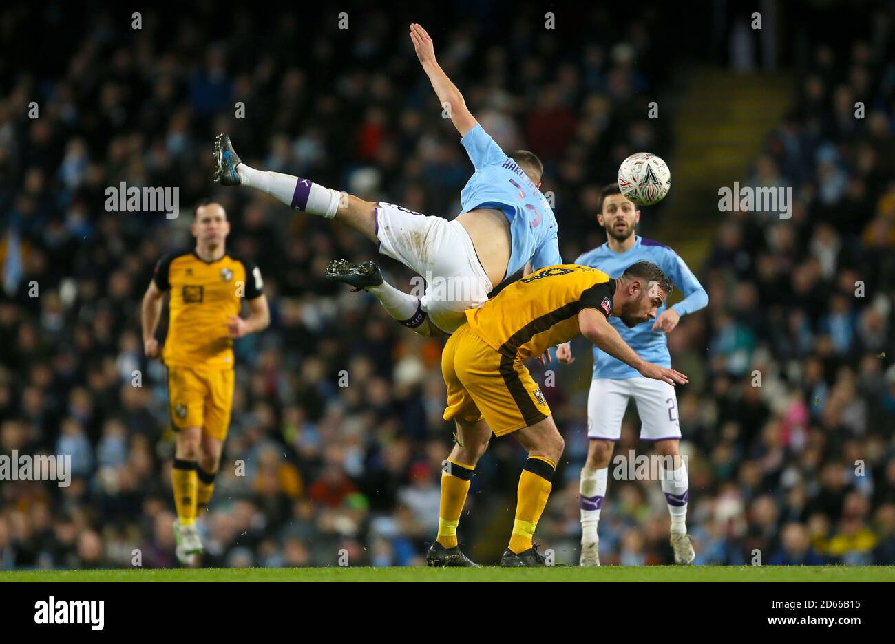Manchester City's Taylor Harwood-Bellis (left) and Port Vale's Tom Pope ...