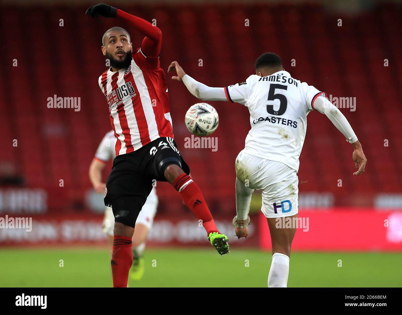 Sheffield United's Leon Clarke (left) and AFC Fylde's Kyle Jameson ...